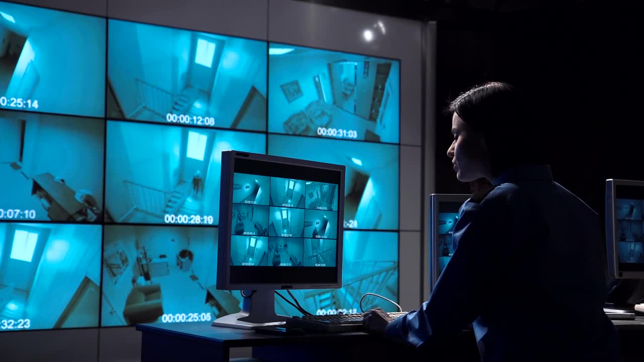 Stock Video A Woman Monitoring Close Circuit Surveillance Live